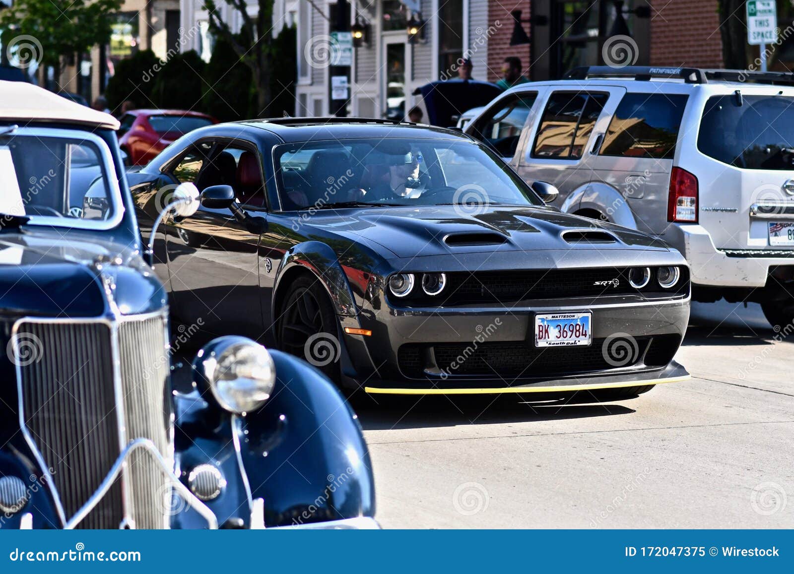 Selective Focus Shot of a Man Driving His Dodge Challenger Car ...
