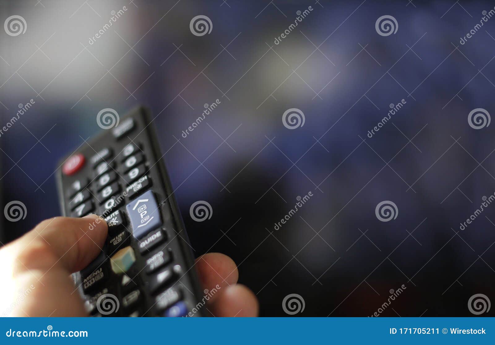 Selective Focus Shot of a Person Pushing the Mute Button on the Remote ...