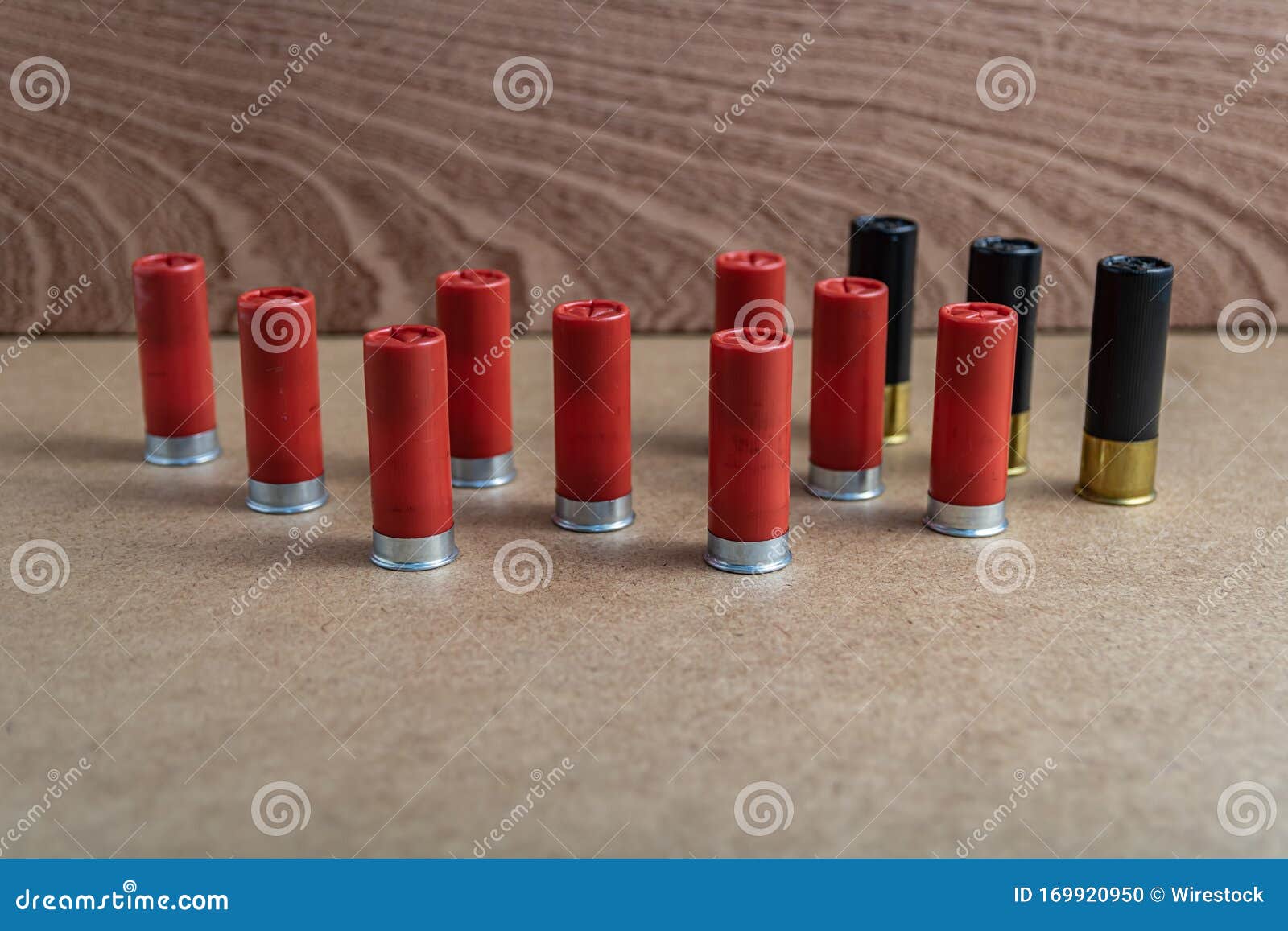 Selective Focus Shot of Red and Black Shotgun Shells on a Brown Surface ...