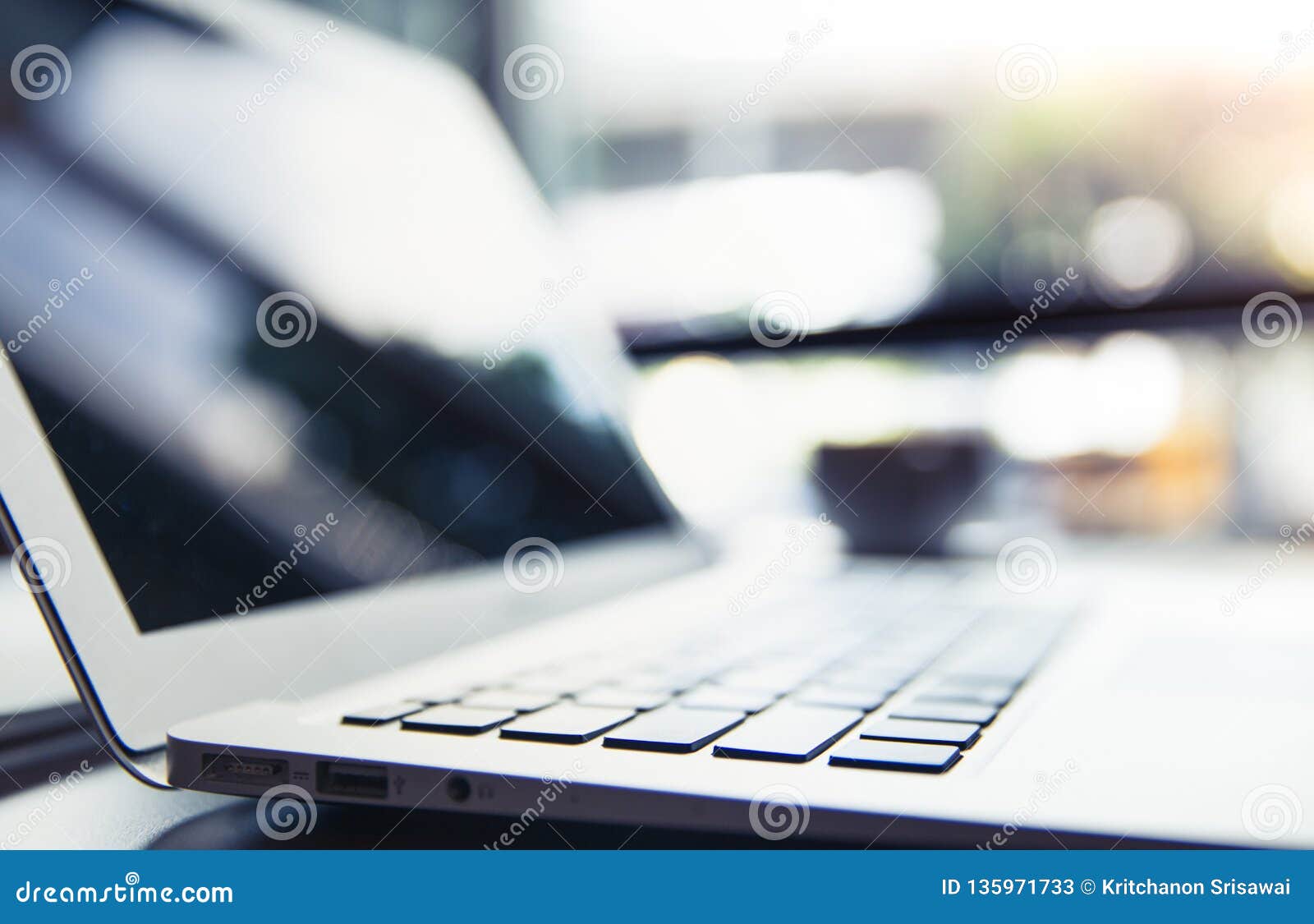 Selective Focus of Side View Laptop is on the Work Table in a Conner ...