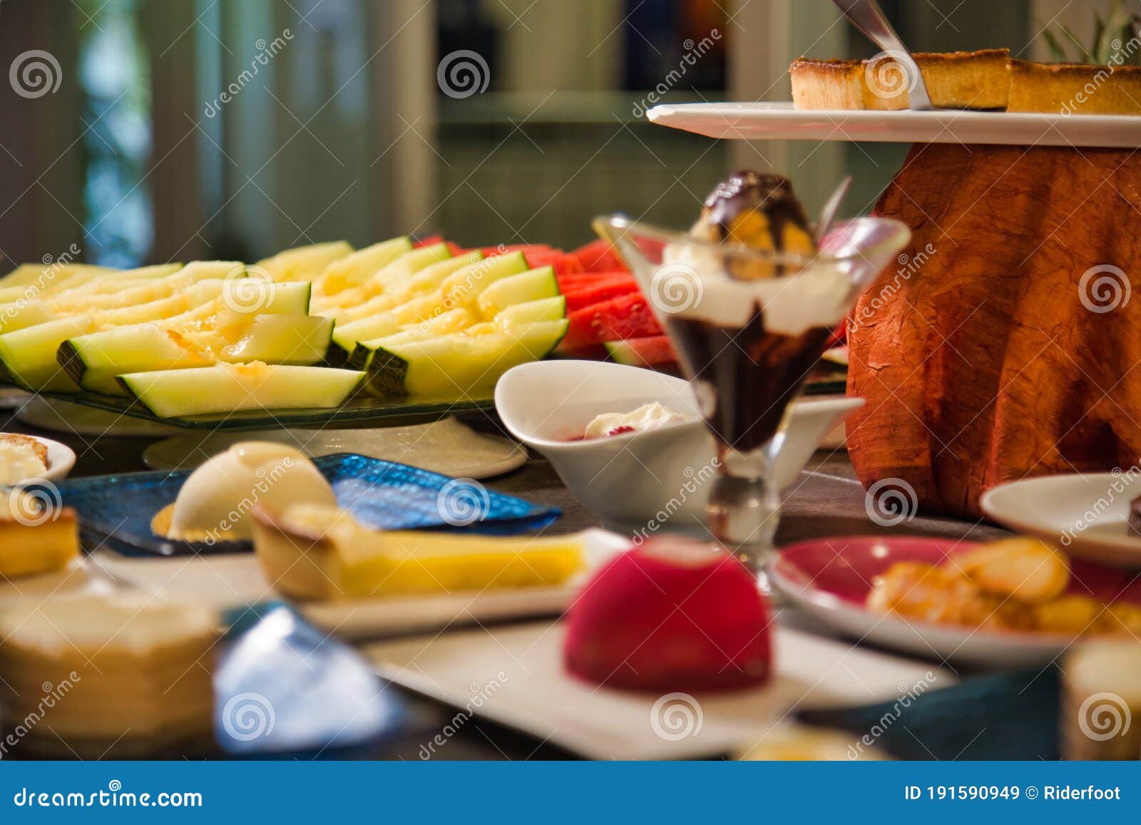 Selective Focus on Slices of Melon on a Table with Varied Desserts ...