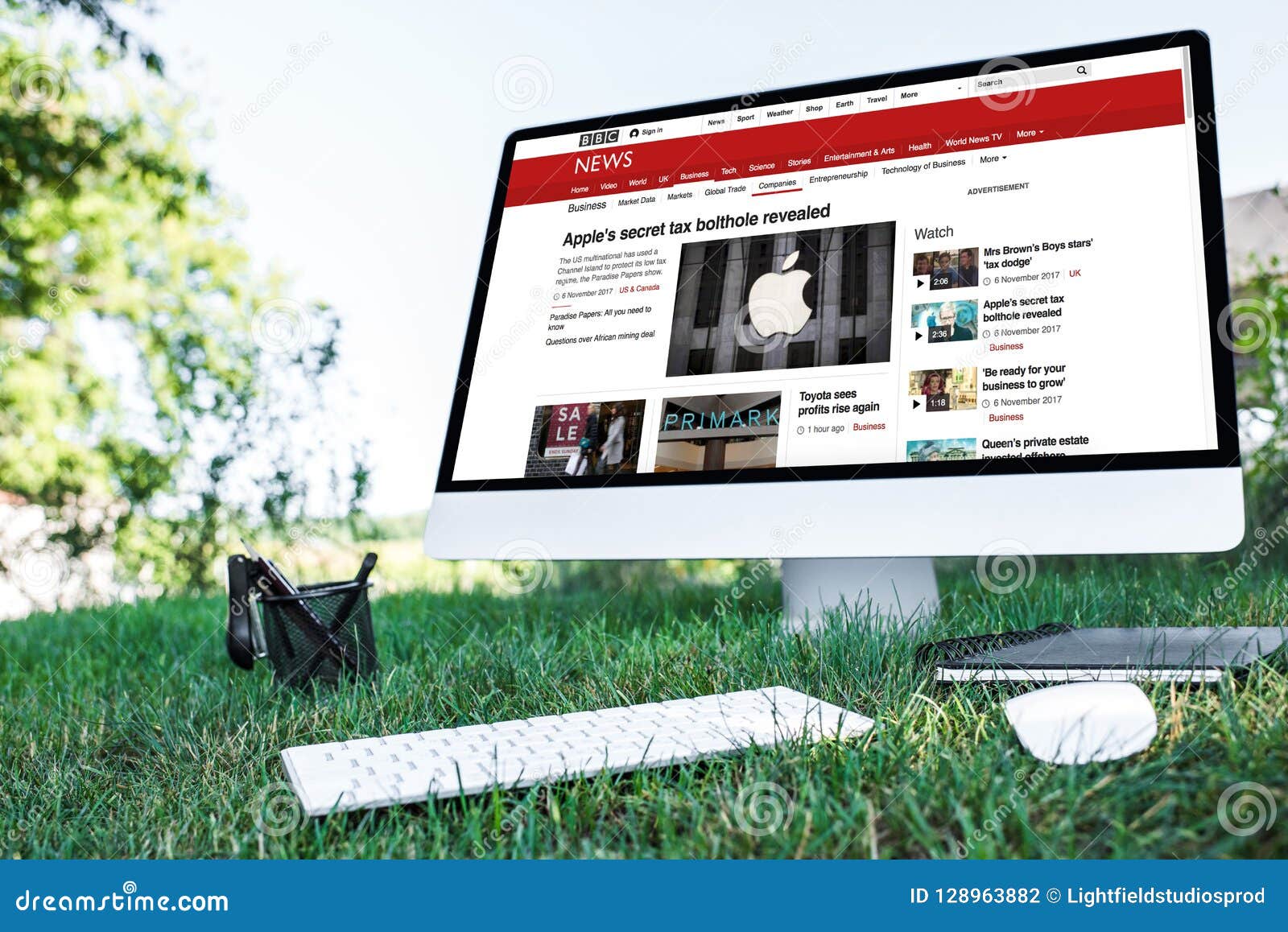 Selective Focus of Textbook and Computer with Bbc News Website on Grass ...