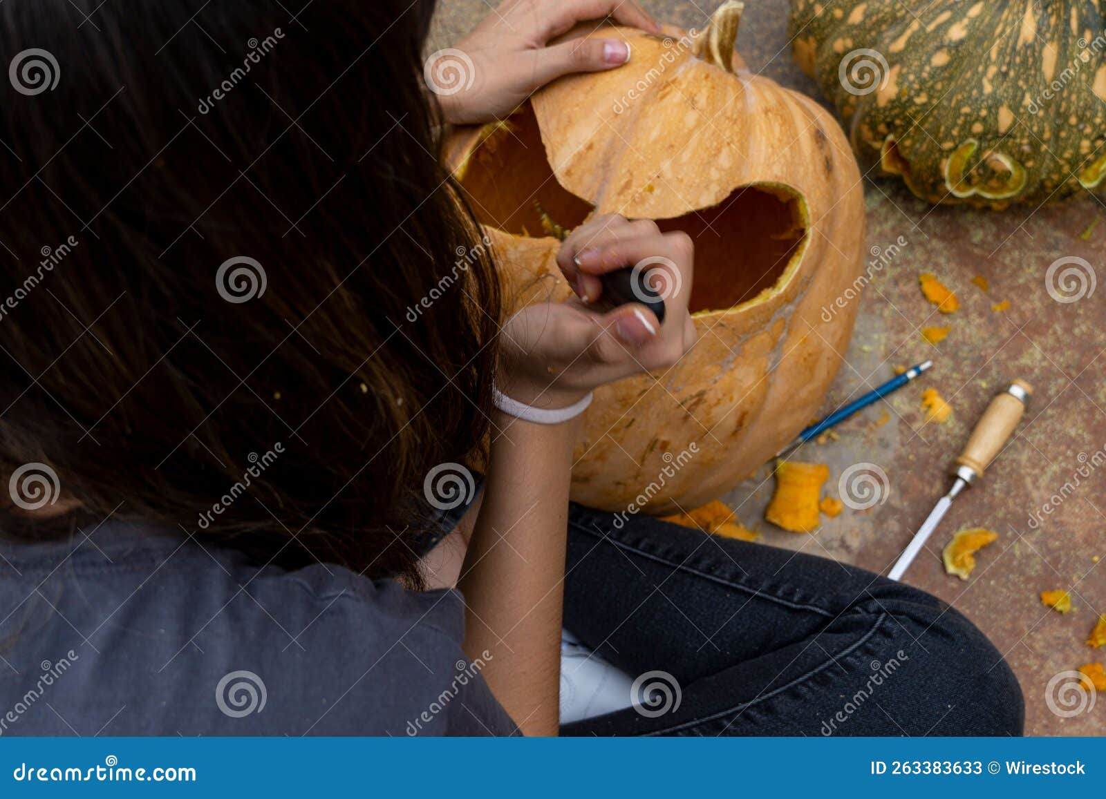 Selective Focus of a Woman Using Sharp Tools To Carve a Scary Face on a ...