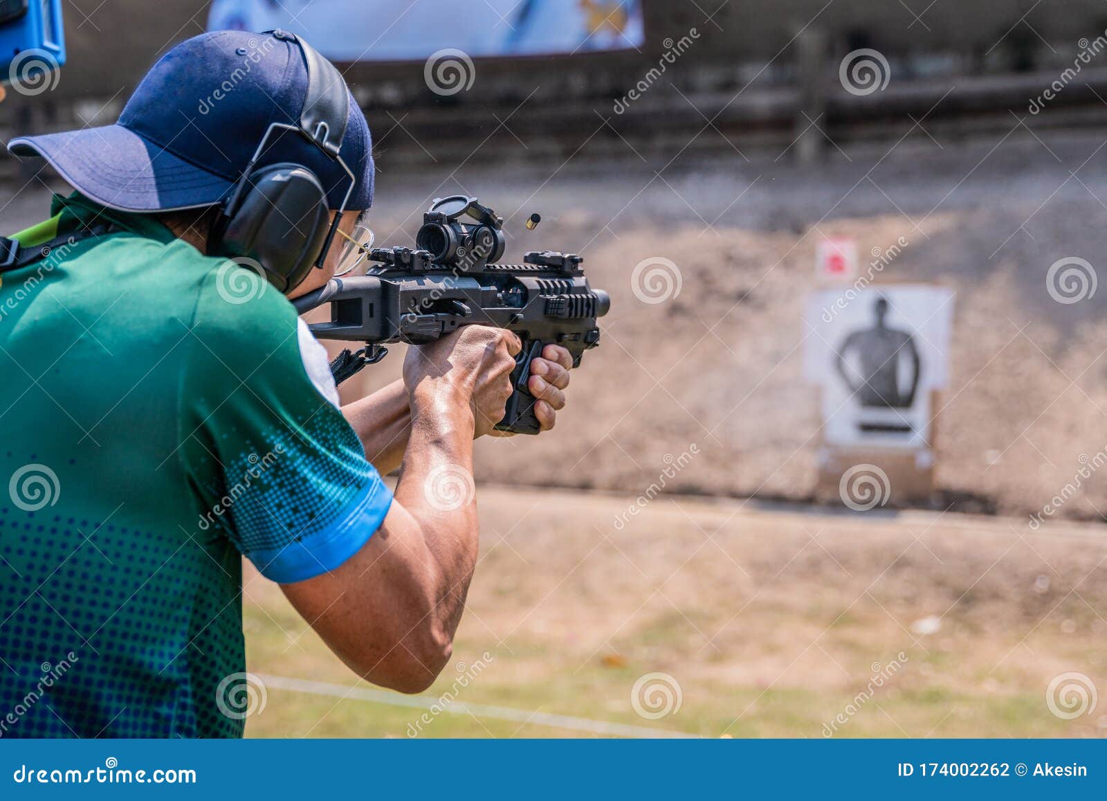 Selective Focus of Man Holding and Fire Sub Machine Gun To Target in ...