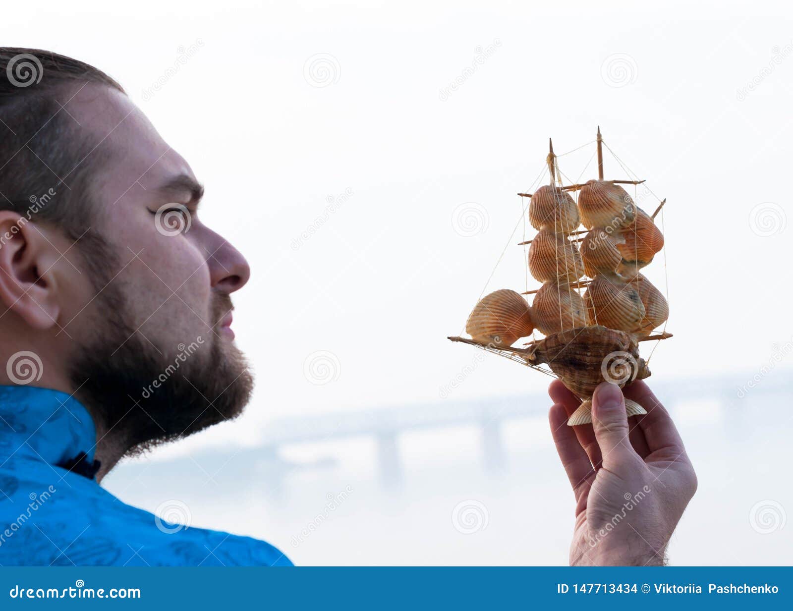 Ship Model with Seashells in Bearded Man Hand in Front of River Stock ...