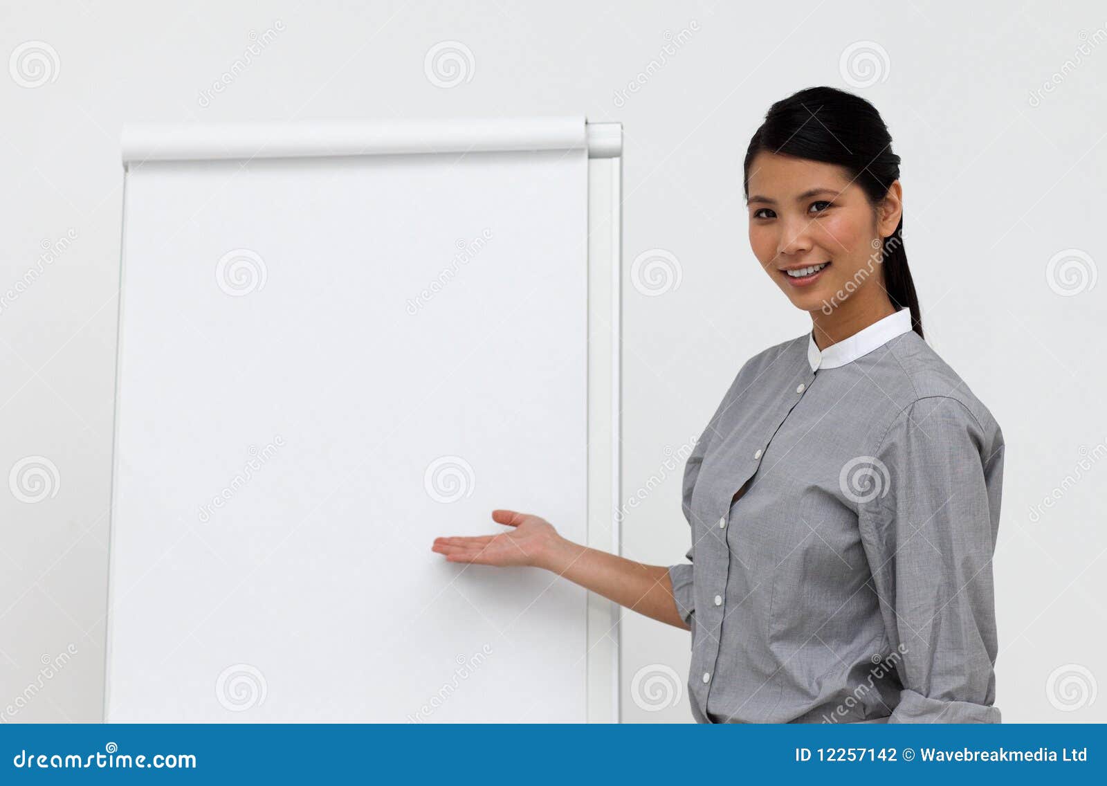 Self-assured Female Executive Pointing at a Board Stock Photo - Image ...