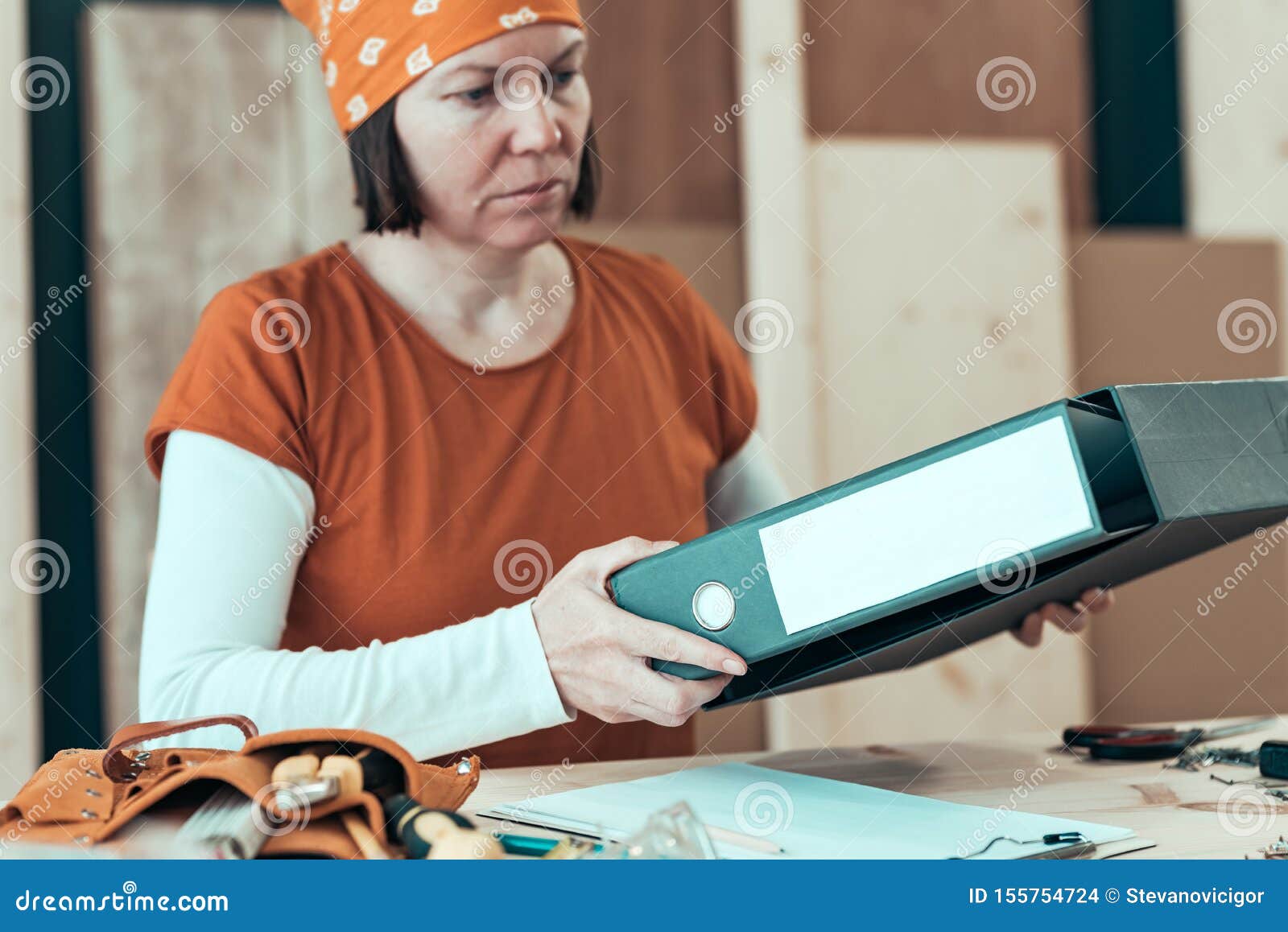 Self Employed Female Carpenter with Document Ring Binder Stock Photo ...