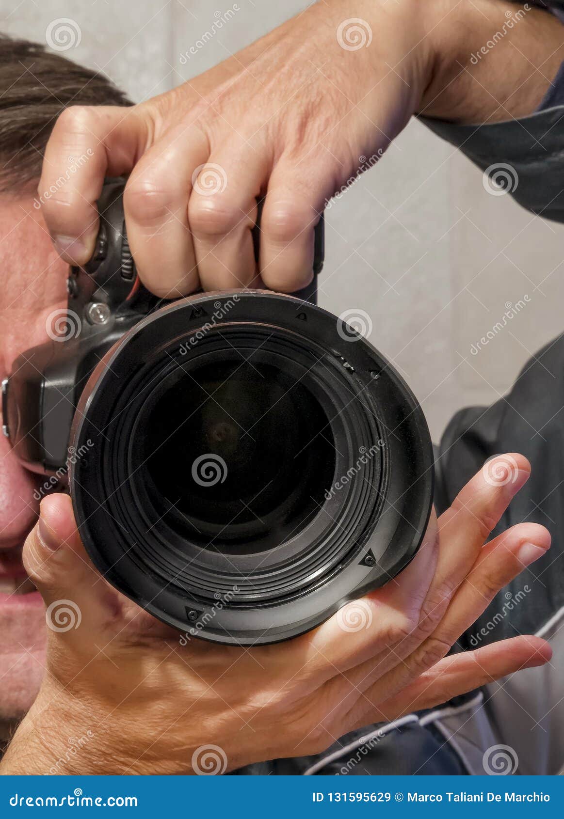 Self-portrait of the Hands in the Mirror Holding a SLR Camera Stock ...