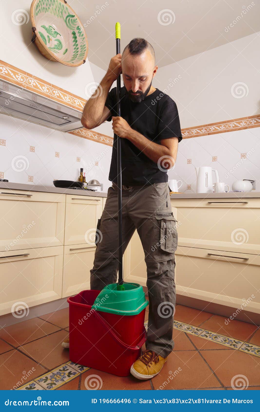 Self-sufficient Young Hispanic Man Squeezing the Mop Stock Photo ...