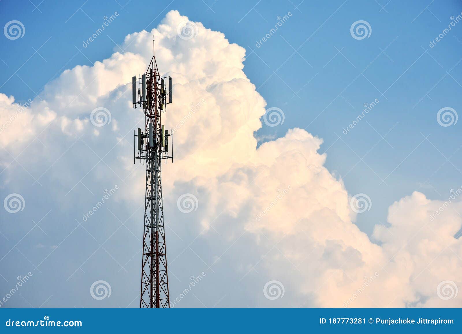 Cellular Transmission Tower with White Clouds and Blue Sky Background ...