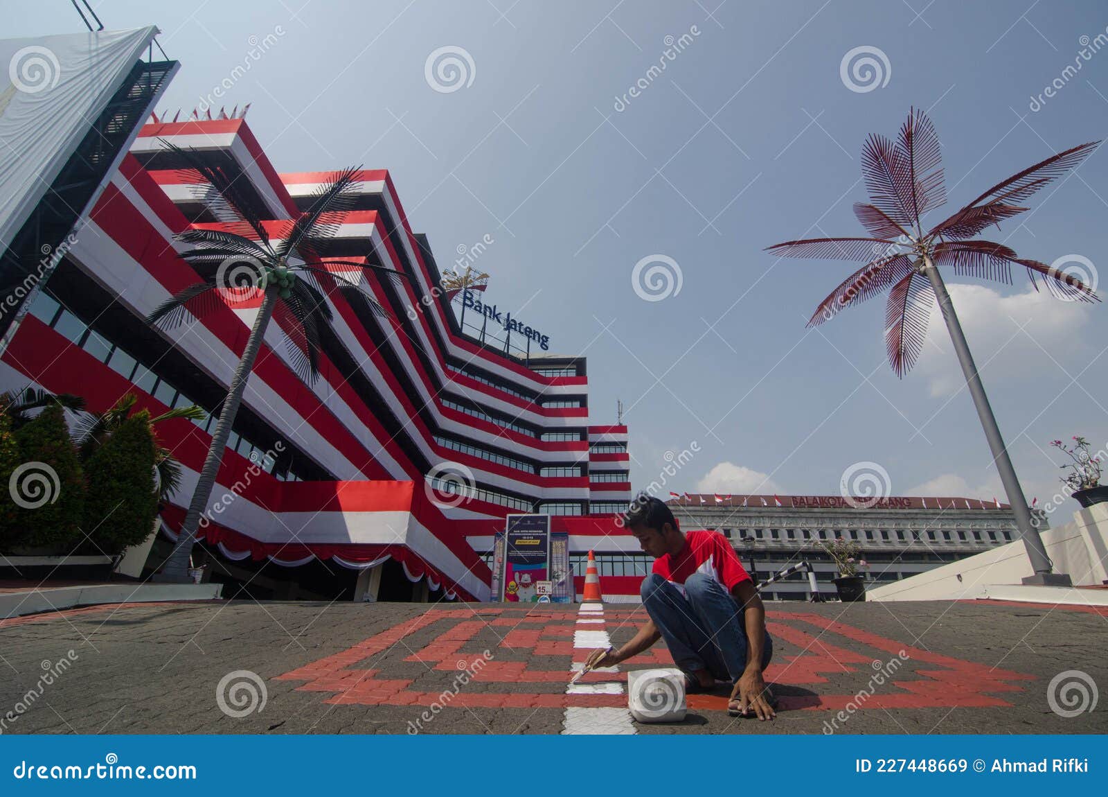 An Officer is Painting Bricks in Front of the Central Java Bank ...
