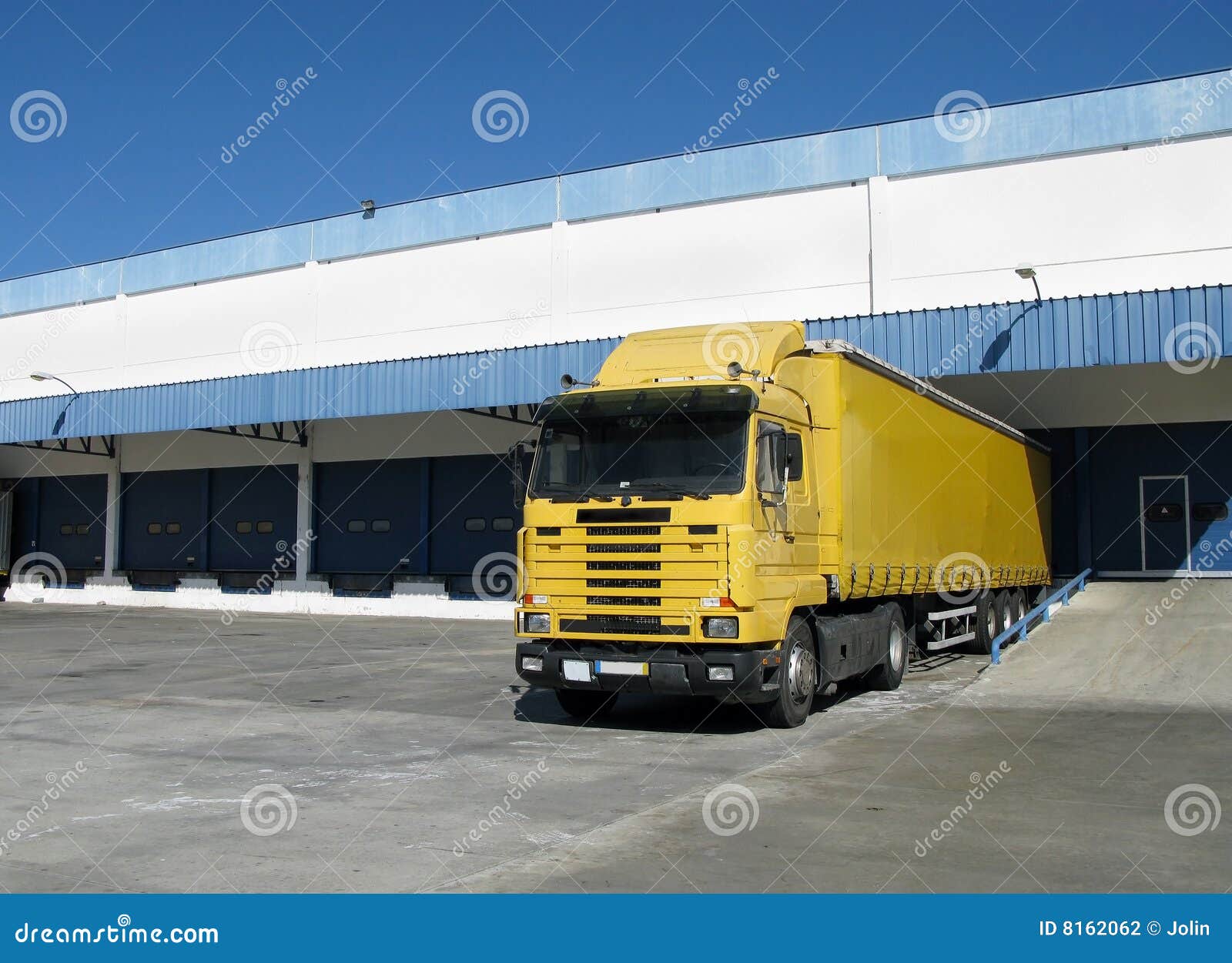 Semi Truck Sitting at a Loading Dock Stock Photo - Image of shipping ...