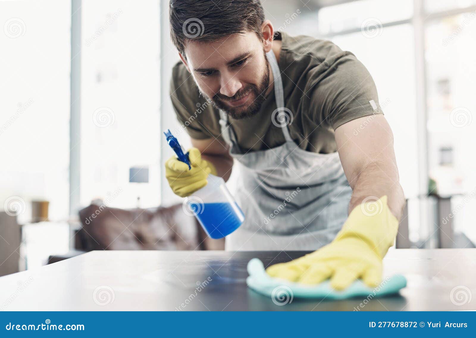 Send those Germs Packing. a Young Man Disinfecting a Table at Home ...