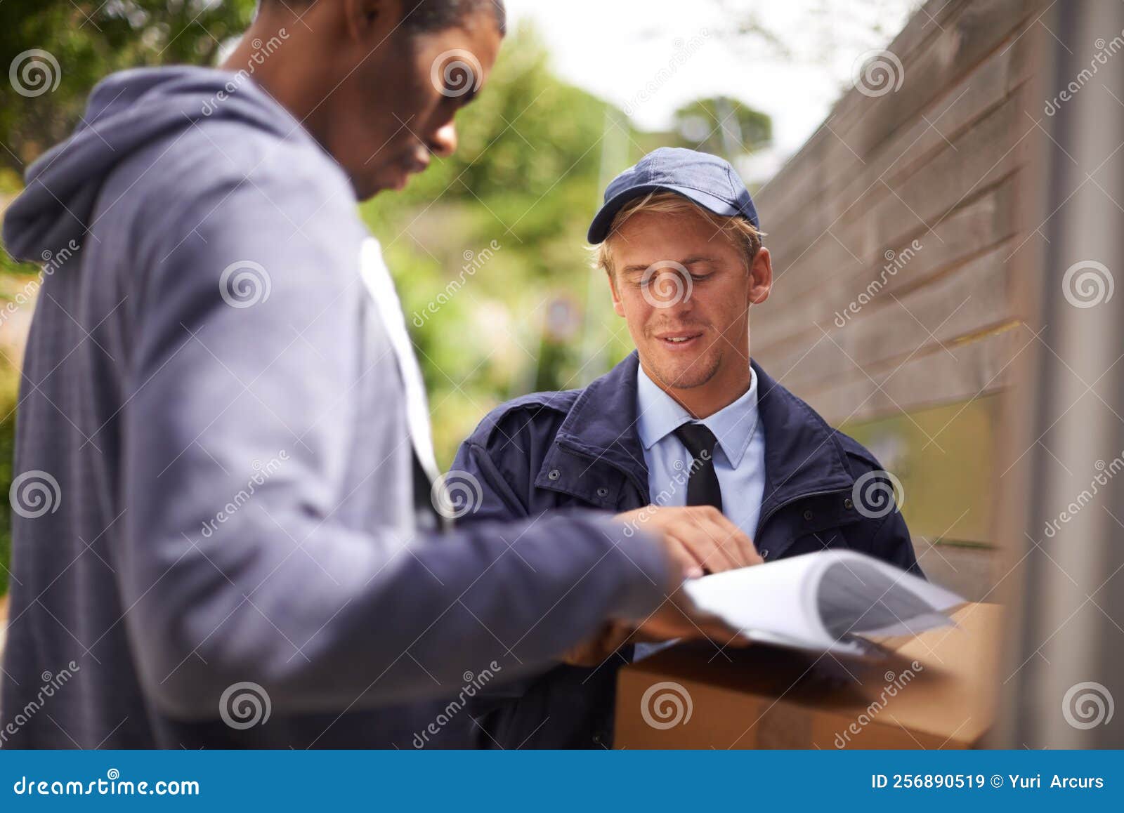 Sending His Things on Their Way. a Handsome Young Man Signing a Form ...
