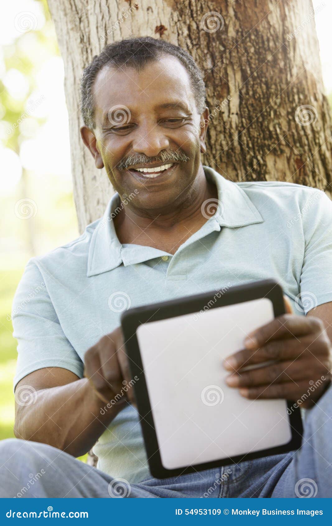 Senior African American Man in Park Using Tablet Computer Stock Image ... Senior African American Man in Park Using Tablet Computer Stock Image ...