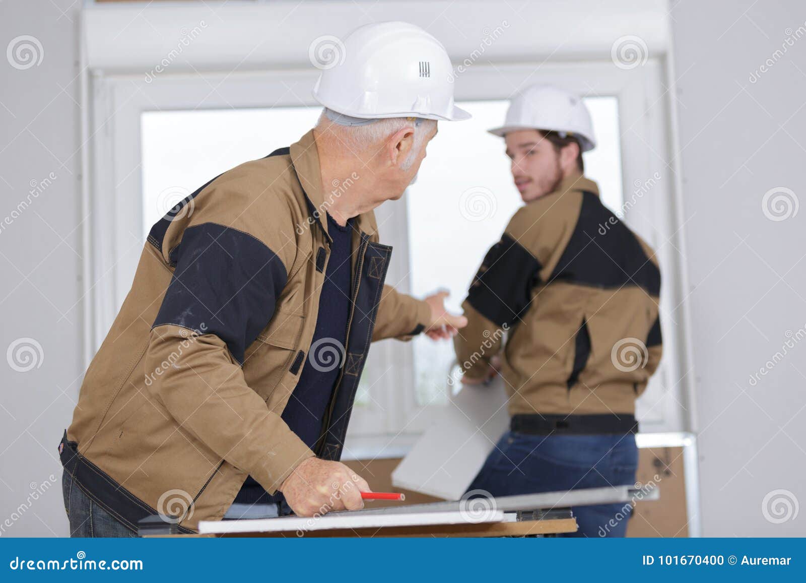 Senior Architect and Young Builder Discussing Stock Photo - Image of ...