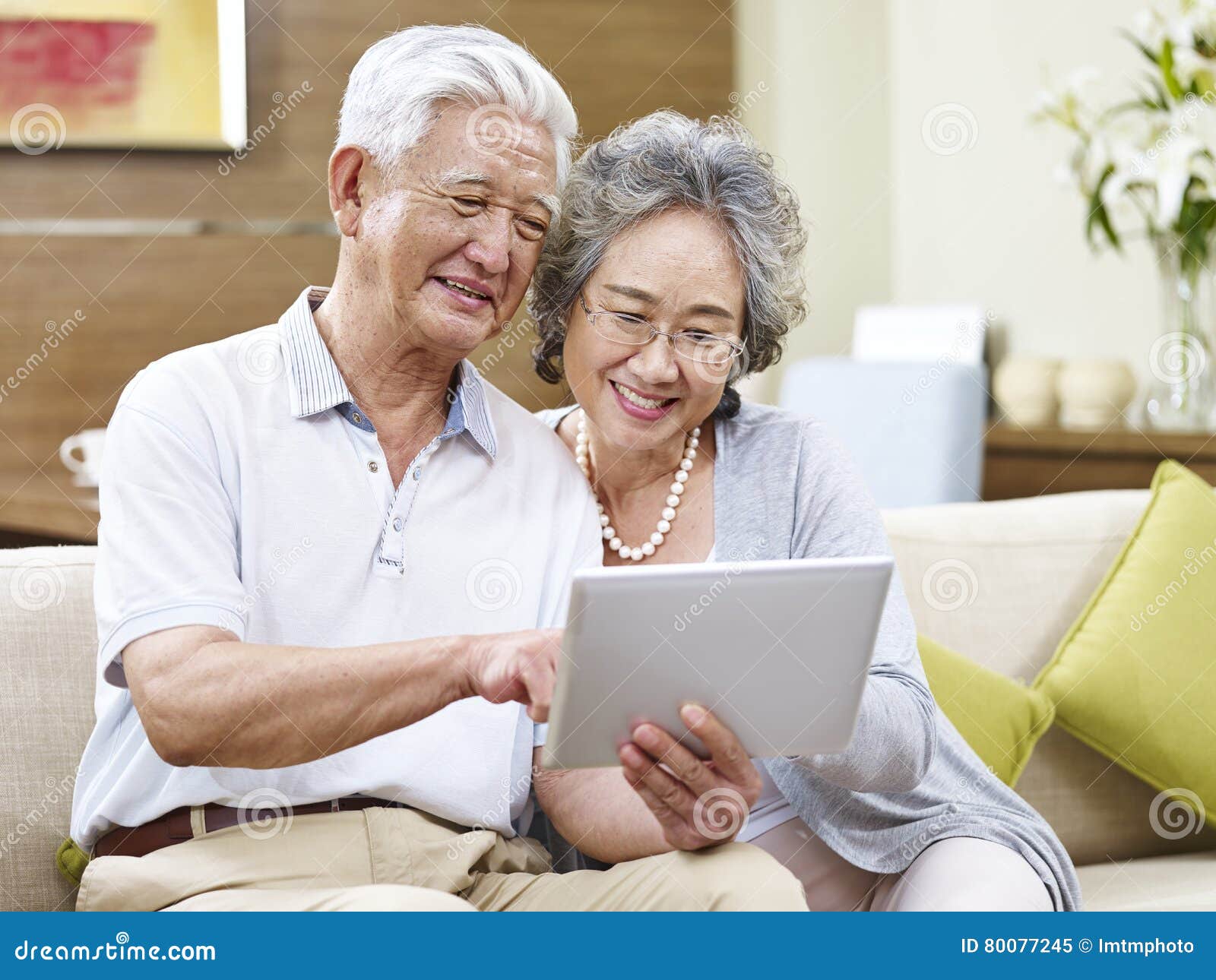 Senior Asian Couple Using A Tablet Computer Together Stock Image