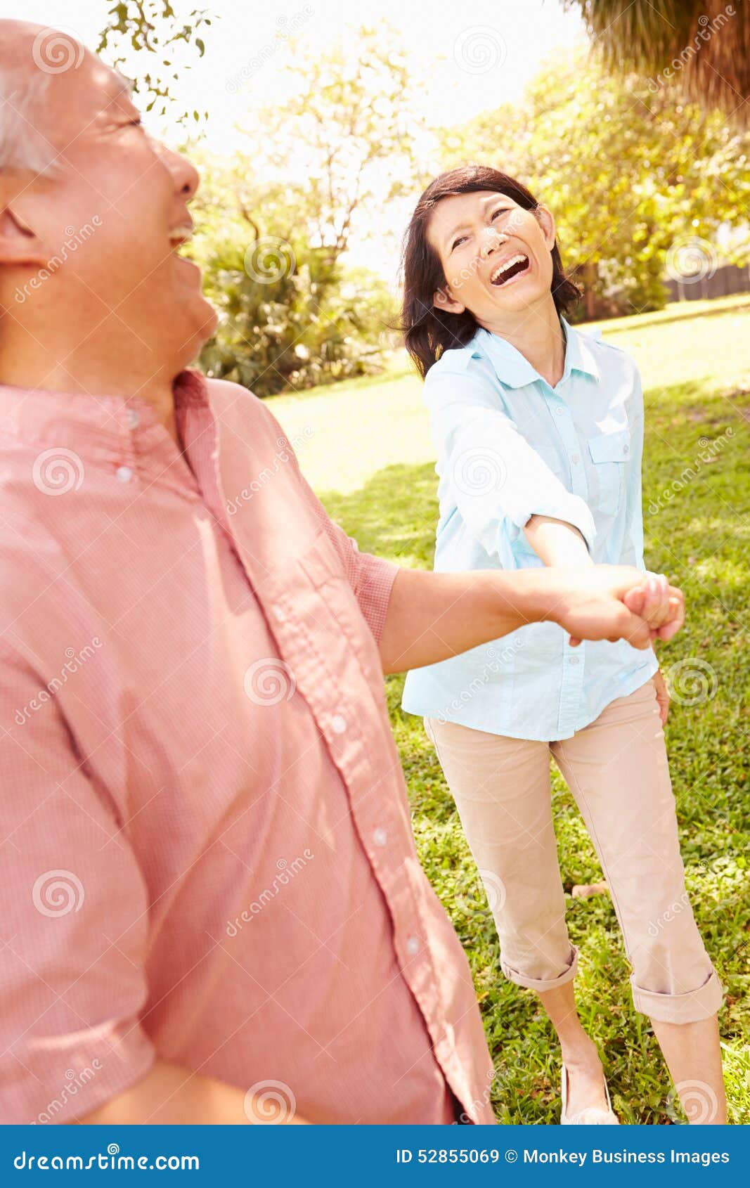 Senior Asian Couple Walking Through Park Together Stock Image Image
