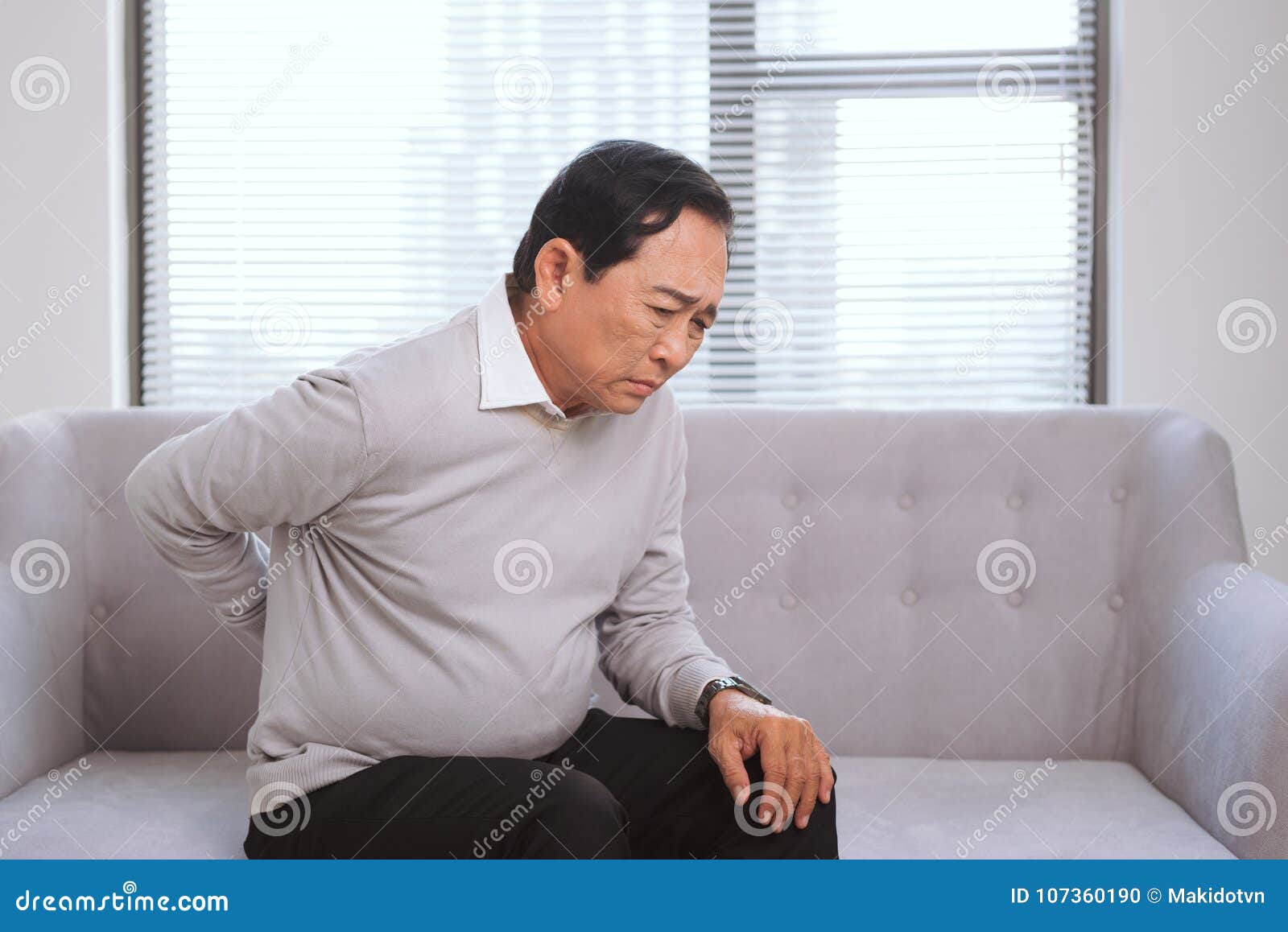 Senior Asian Man with Pain in Back Sitting on Sofa Stock Photo - Image ...