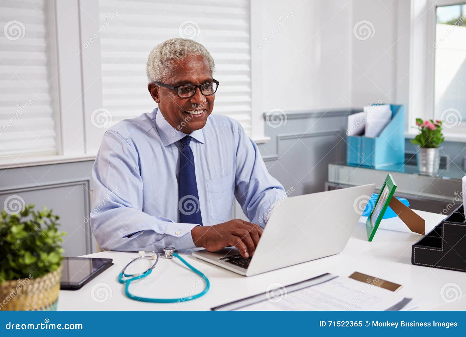 Senior Black Male Doctor at Work Using Laptop in an Office Stock Image ...