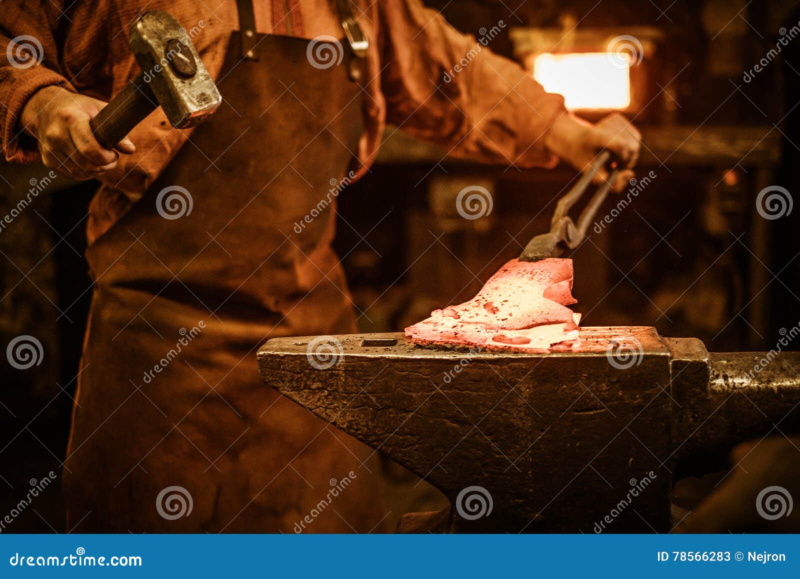 Senior Blacksmith Forging the Molten Metal on the Anvil in Smithy Stock ...