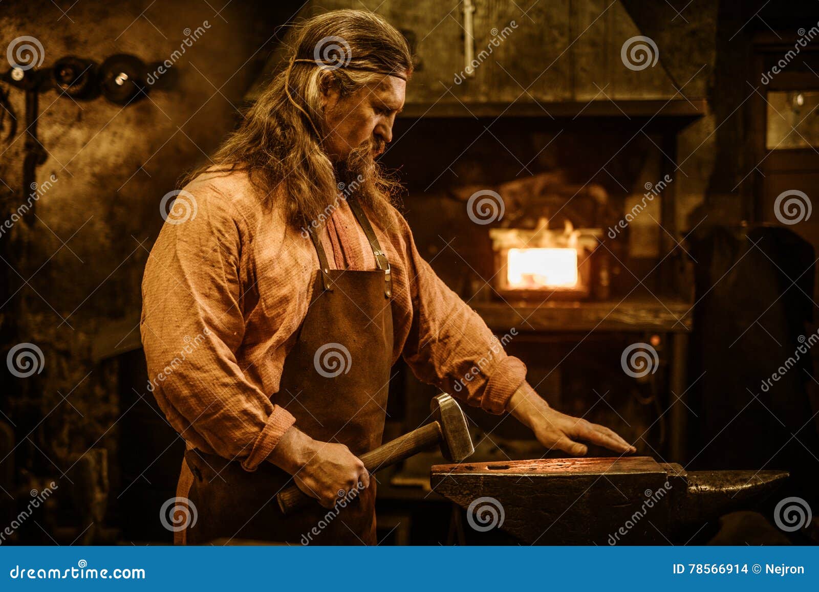 Senior Blacksmith Forging the Molten Metal on the Anvil in Smithy Stock ...