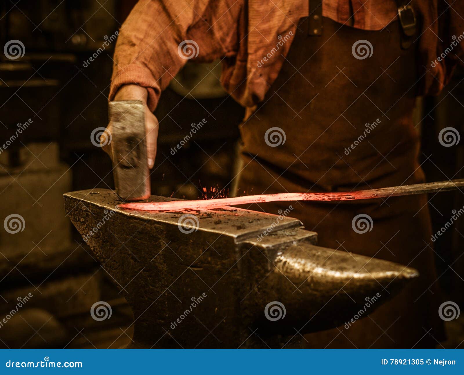 Senior Blacksmith Forging the Molten Metal on the Anvil in Smithy Stock ...