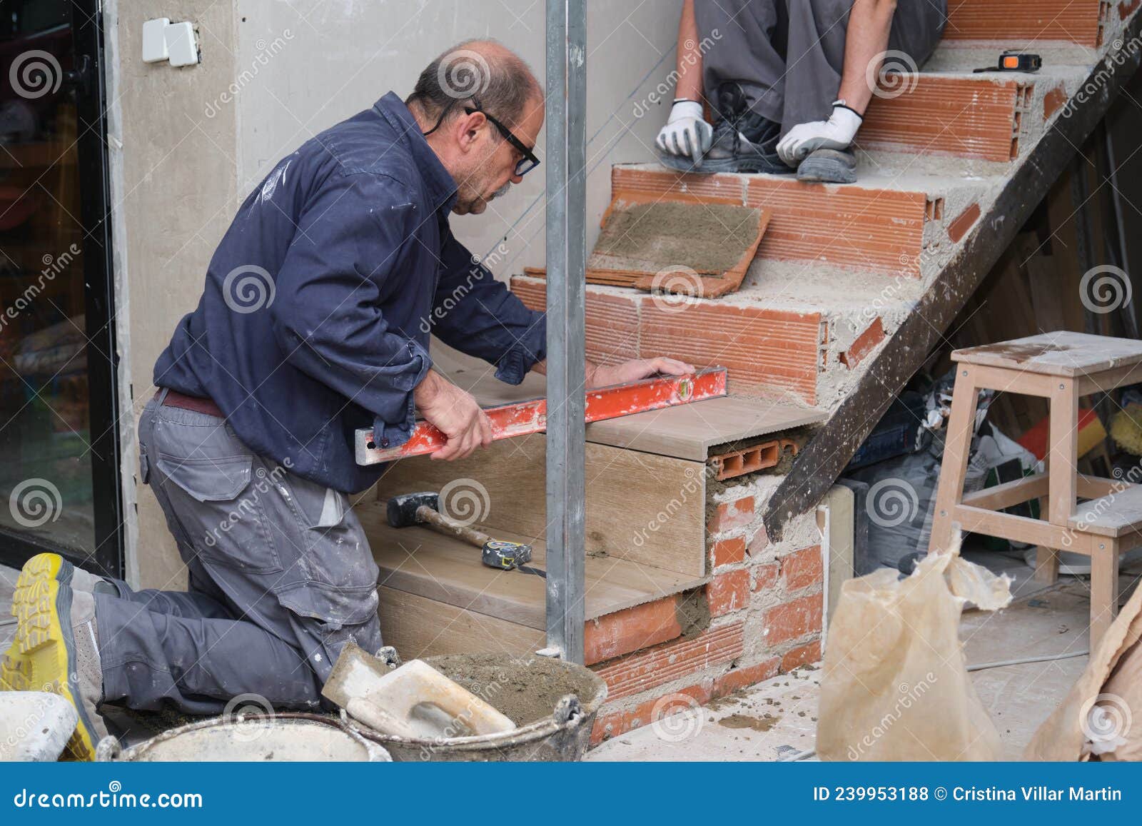 Senior Bricklayer Using a Spirit Level To Check the Step is Horizontal ...