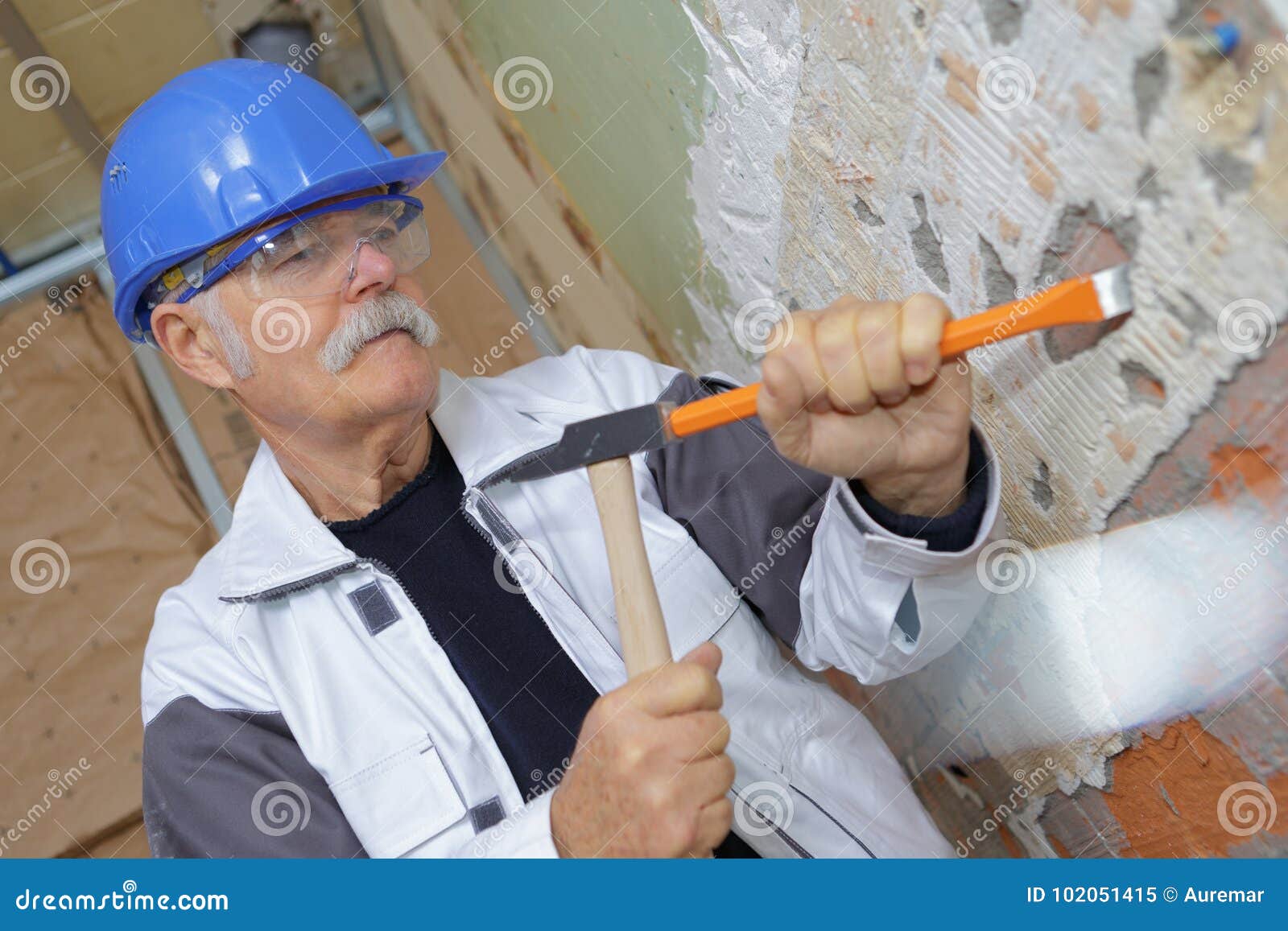 Senior Builder Using Hammer To Remove Walls Plaster Stock Image - Image ...
