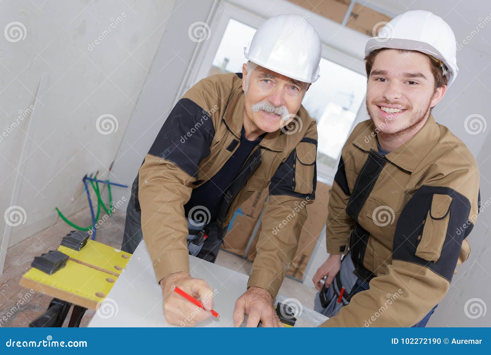 Senior Builder and Young Builder Discussing New Project Stock Photo ...