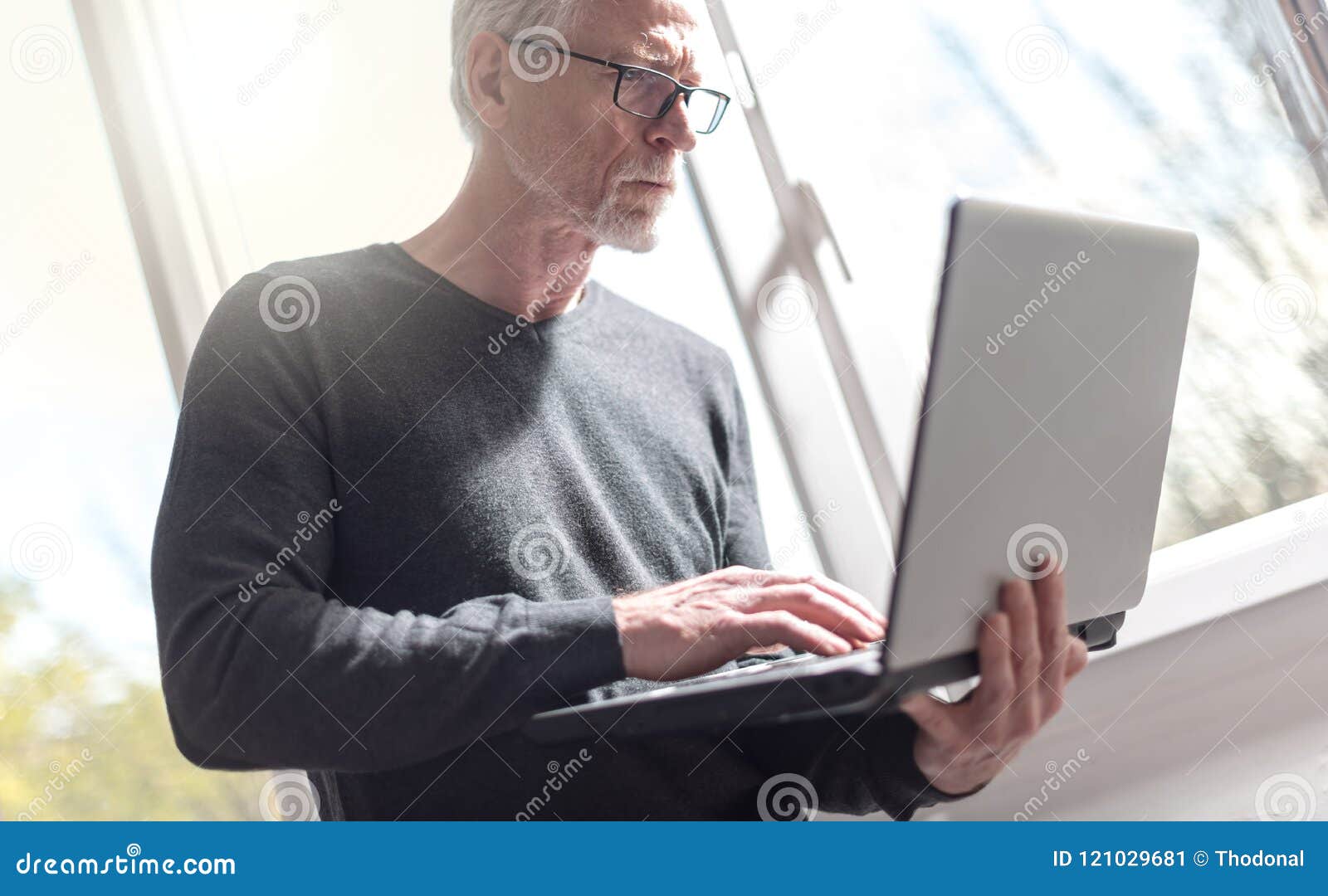 Senior Businessman Standing and Working on His Laptop Stock Image ... Senior Businessman Standing and Working on His Laptop Stock Image ...