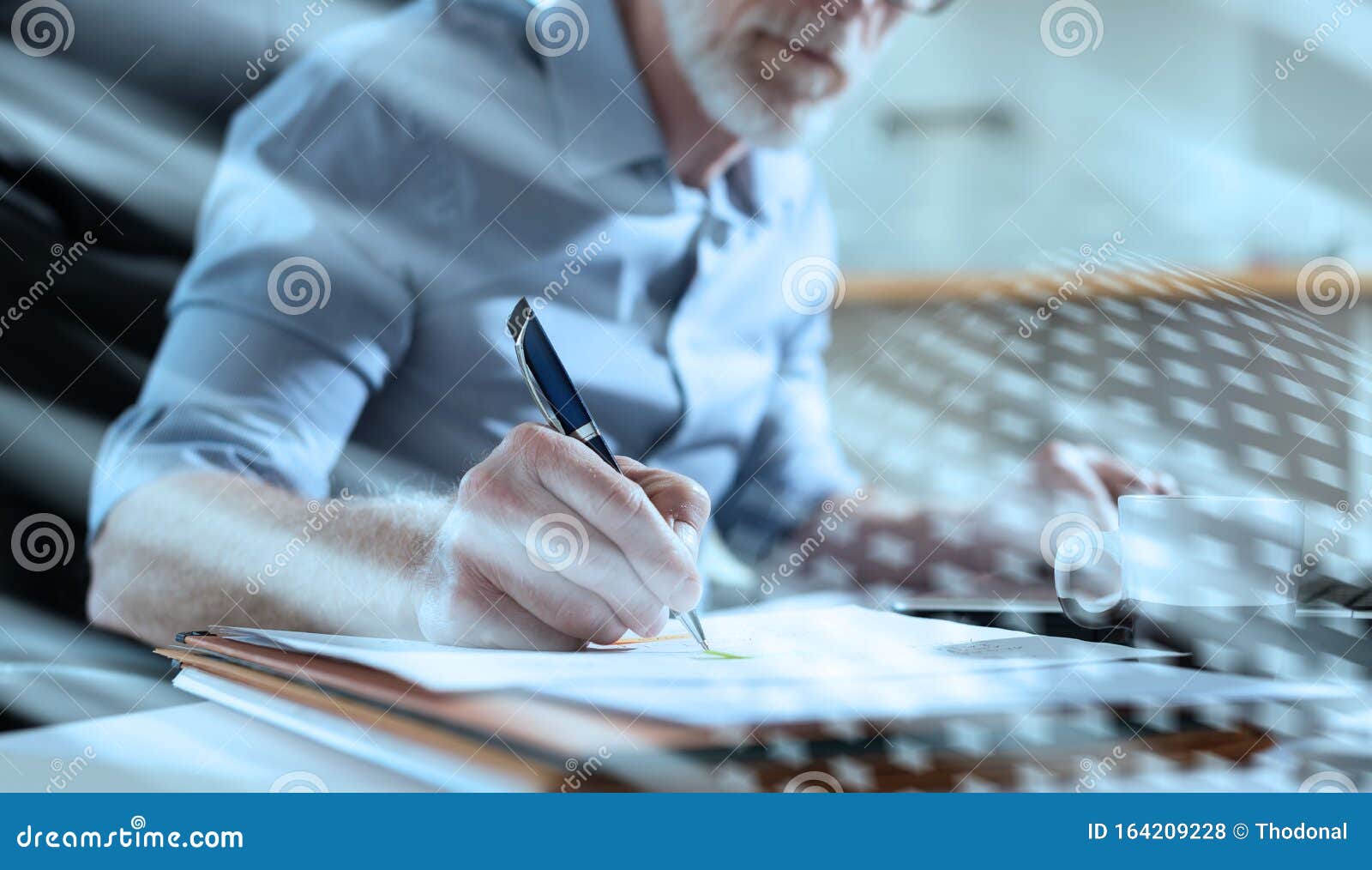 Senior Businessman Taking Notes, Hard Light; Light Effect Stock Photo ...