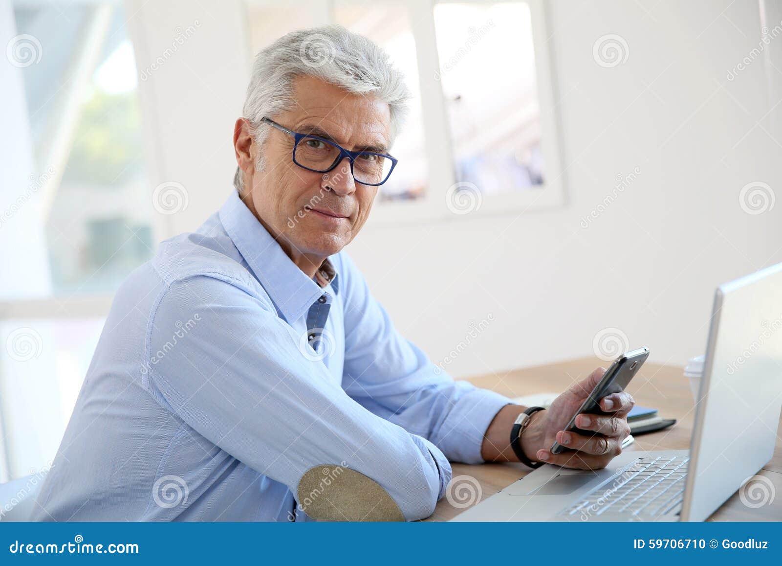 Senior Businessman Using Smartphone and Laptop Stock Photo - Image of ...