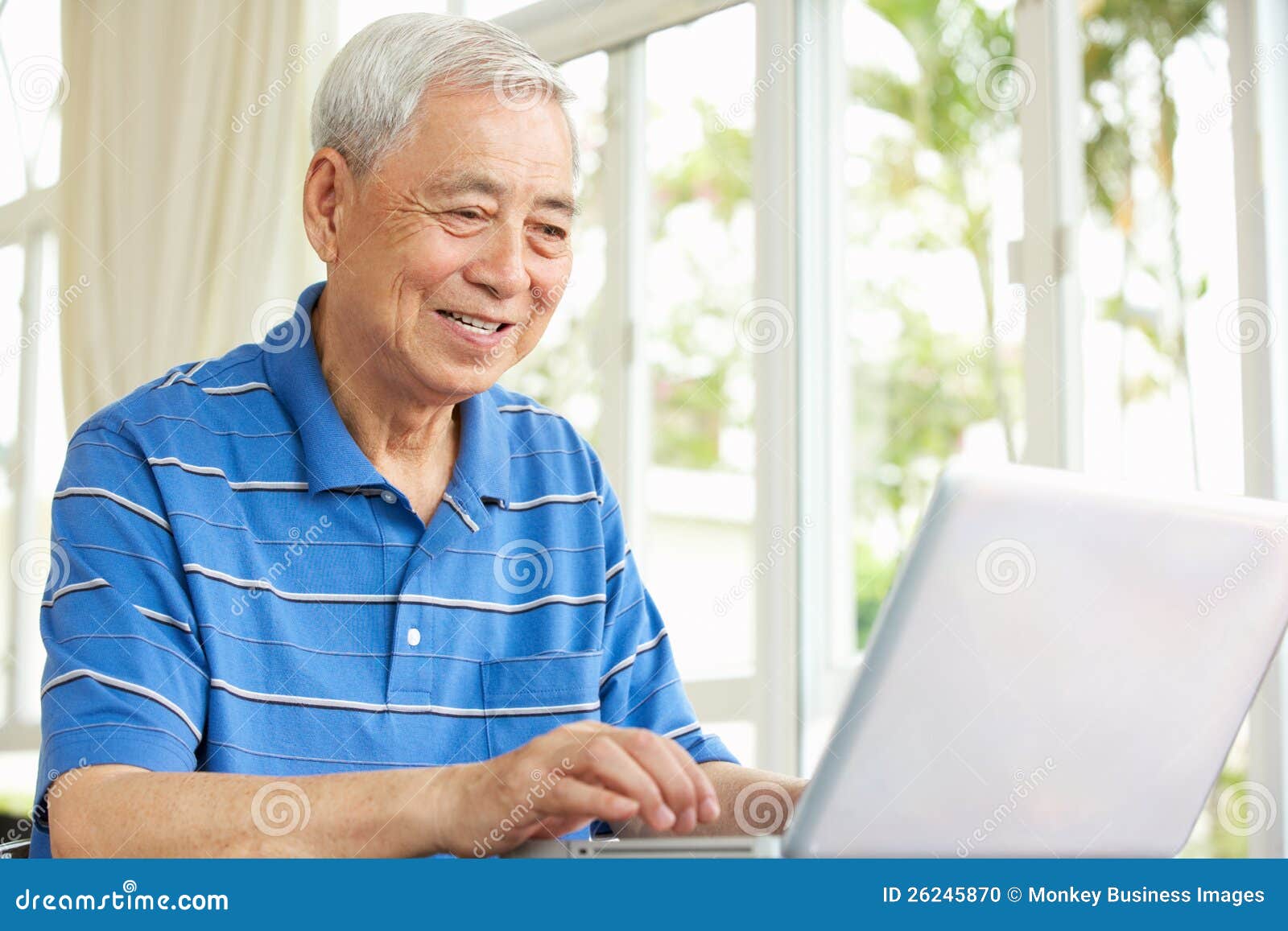Senior Chinese Man Sitting Using Laptop at Home Stock Photo - Image of ...
