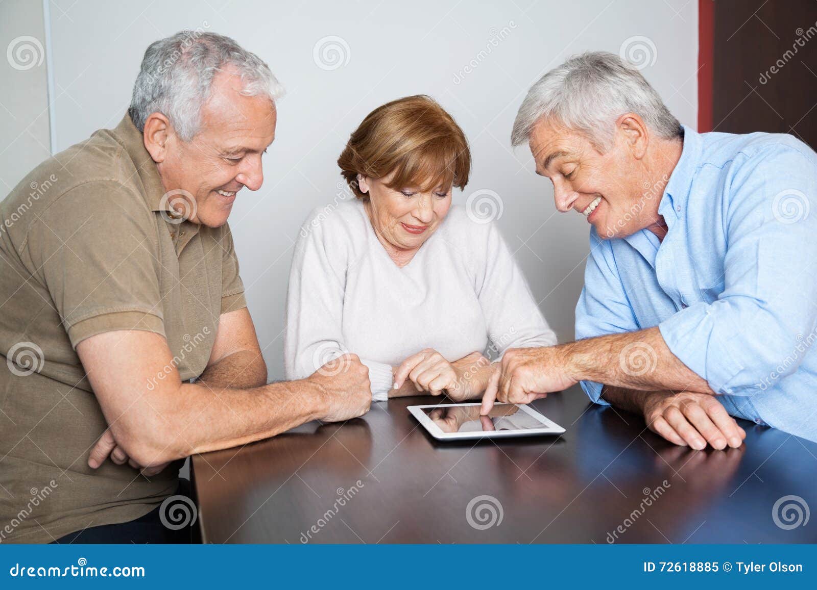 Senior Classmates Watching Man Using Digital Tablet at Desk Stock Image ...