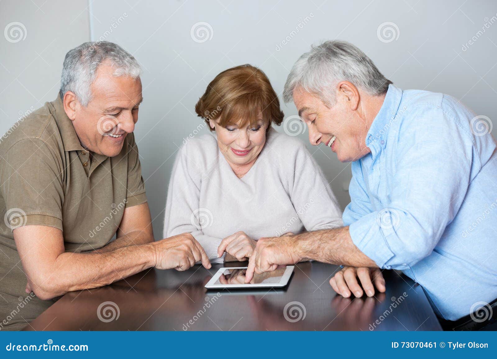 Senior Classmates Watching Man Using Digital Tablet at Desk Stock Image ...