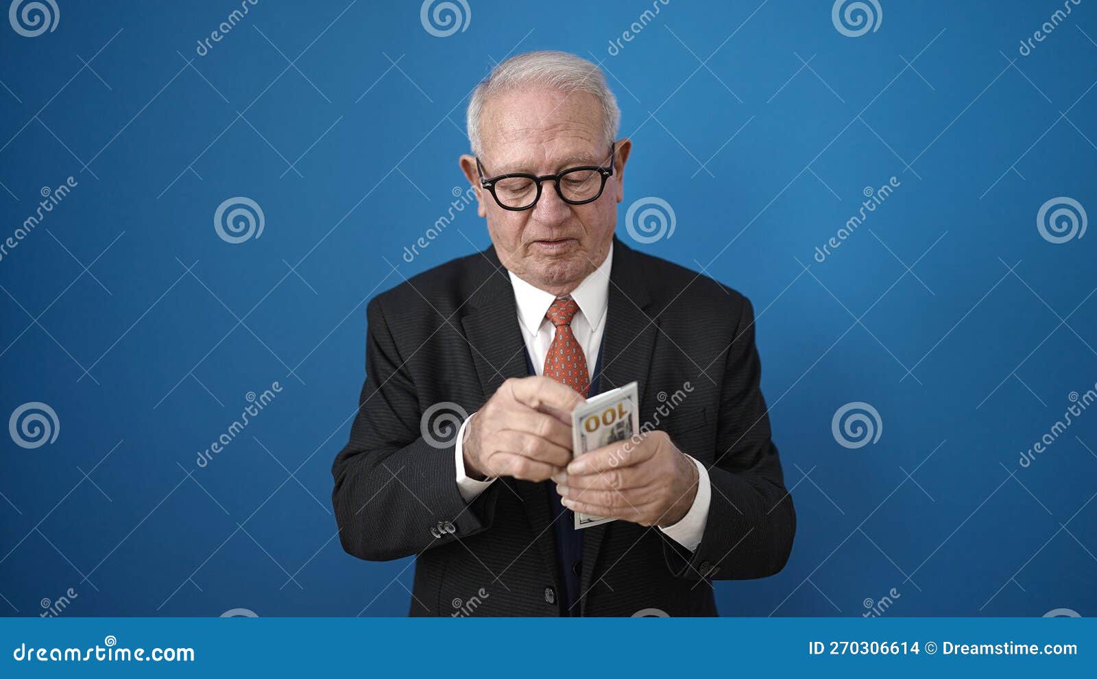 Senior Counting Dollars Over Isolated Blue Background Stock Photo ...