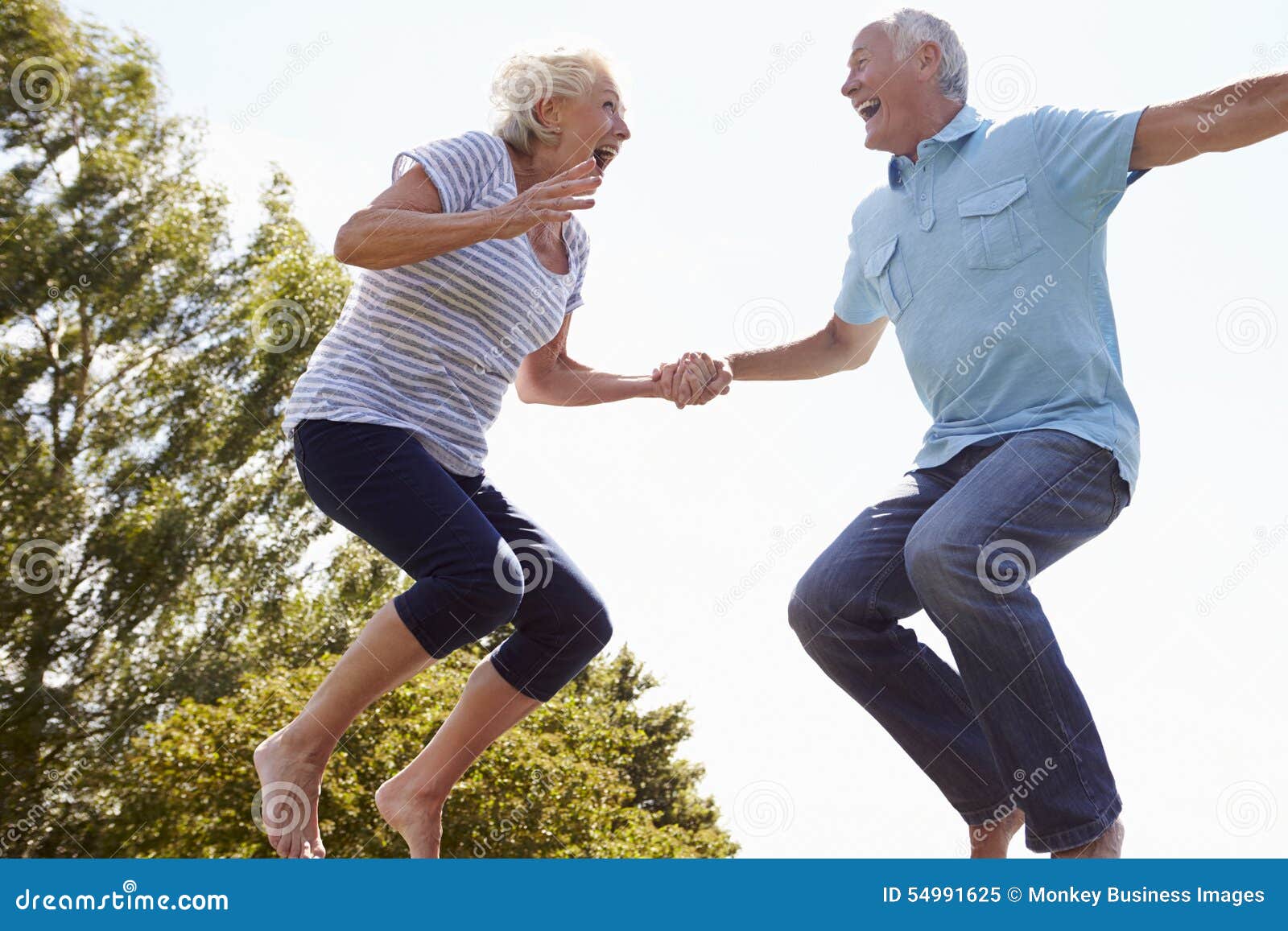 Senior Couple Bouncing on Trampoline in Garden Stock Image - Image of ...