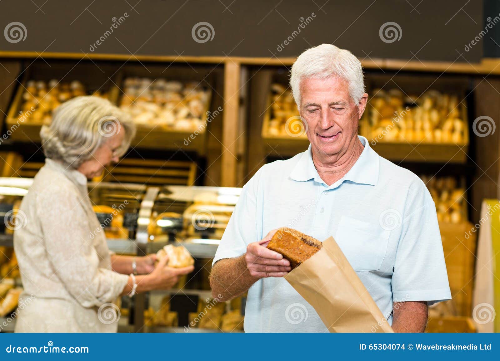 Senior couple buying bread stock photo. Image of female - 65304074