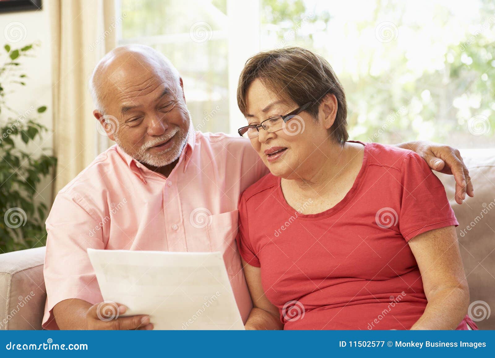 Senior Couple Discussing Document at Home Stock Image - Image of adult ...