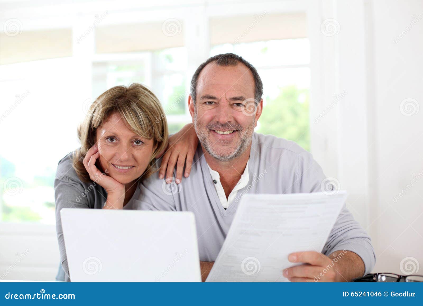 Senior Couple Doing Paperwork and Using Laptop Stock Photo - Image of ...
