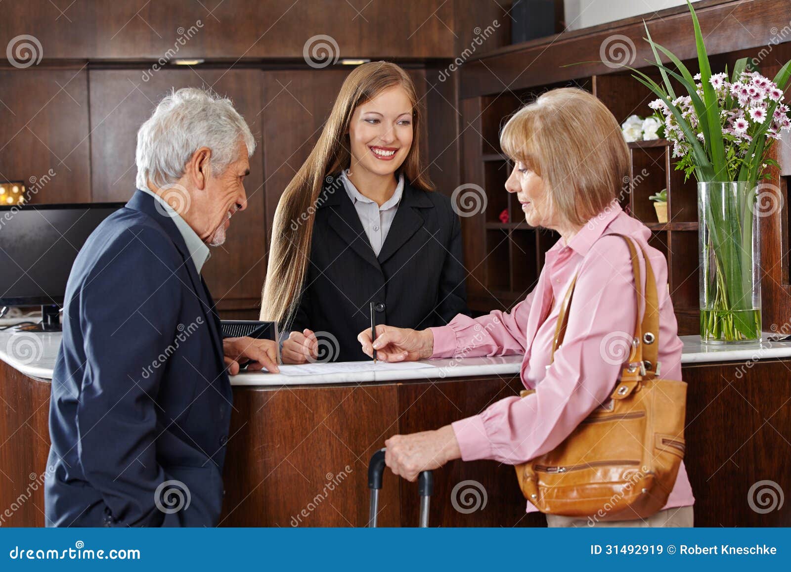 Senior Couple in Hotel Signing Form Stock Image - Image of staff, write ...