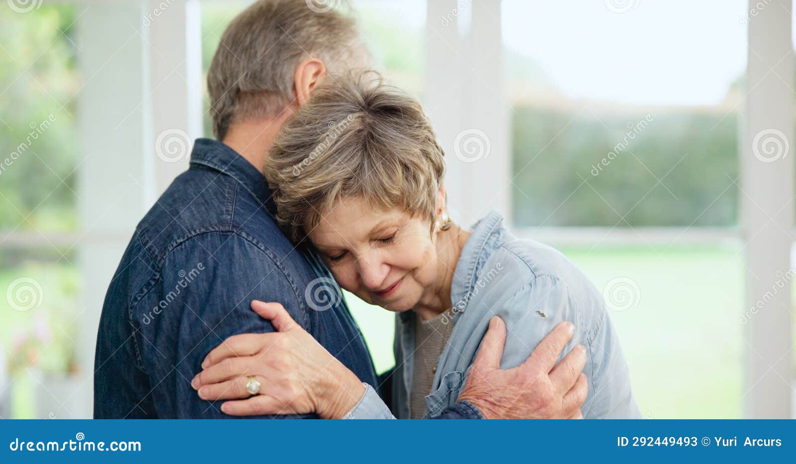Senior Couple Hug And Love With Forehead Kiss In Home In Retirement