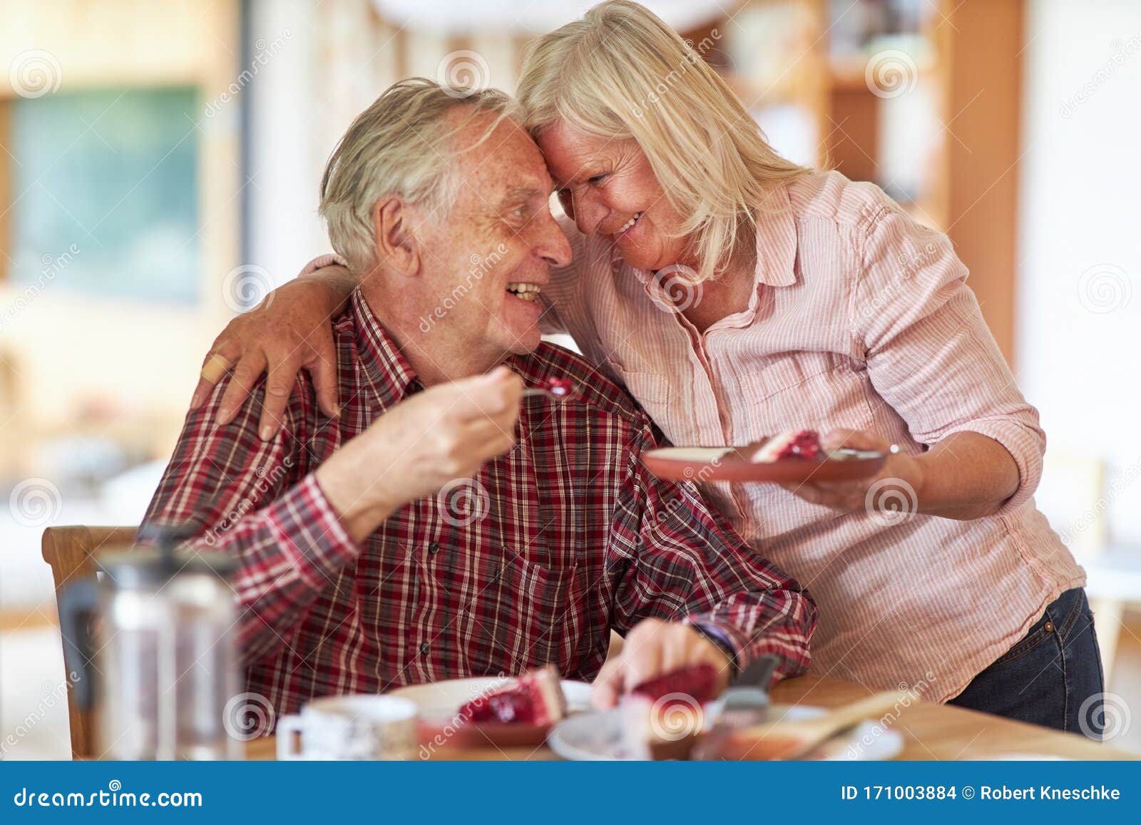 Senior Couple Hugging Each Other while Eating Cake Stock Photo - Image ...