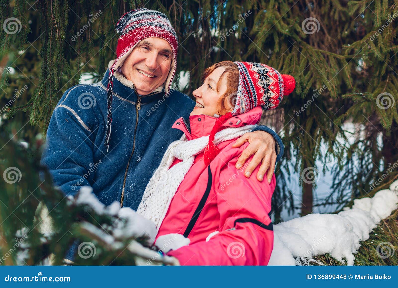 Senior Couple Hugging And Laughing In Winter Forest Man And Woman