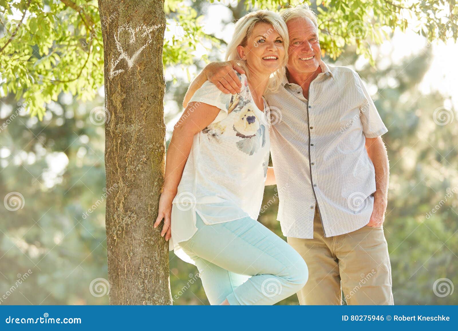 Senior Couple Hugging Under a Tree Stock Photo - Image of leisure ...