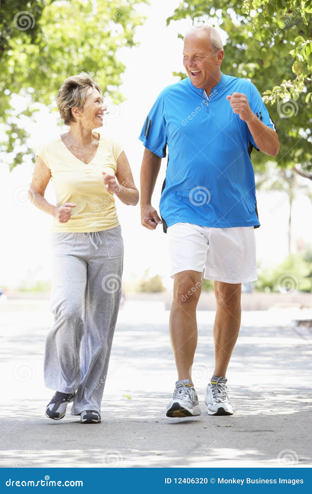 Senior Couple Jogging in Park Stock Photo - Image of laughing, vertical ...
