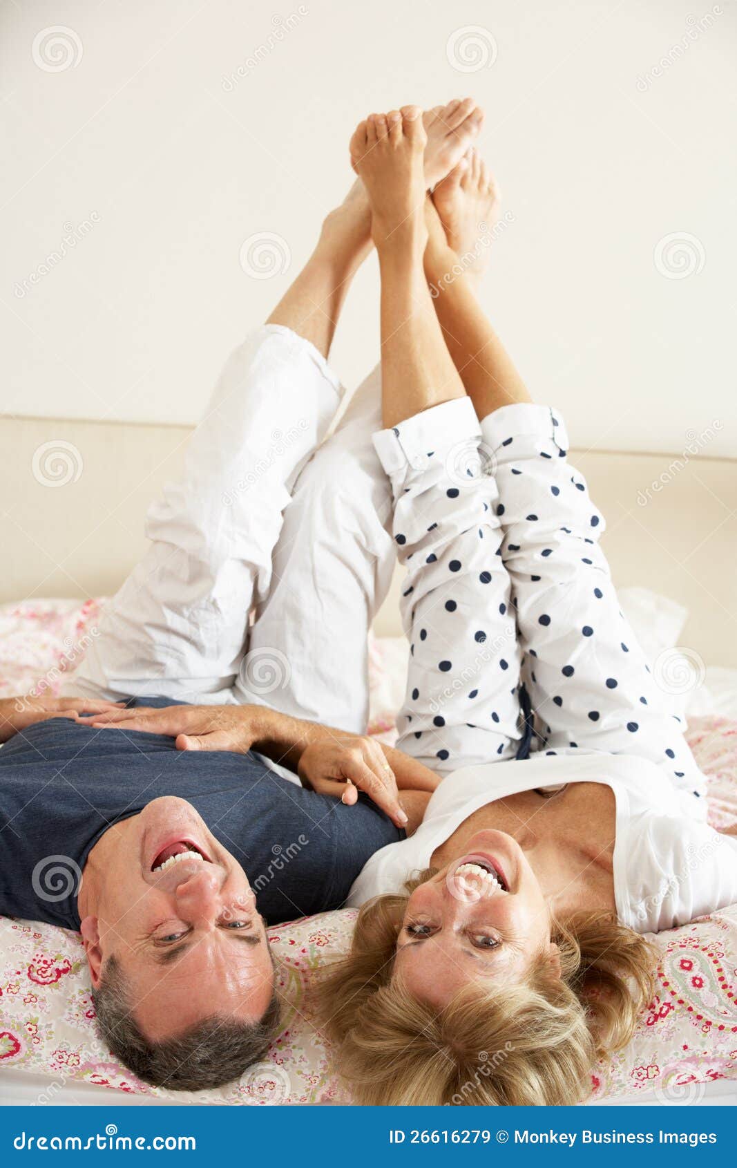 Senior Couple Lying Upside Down Together in Bed Stock Image - Image of ...