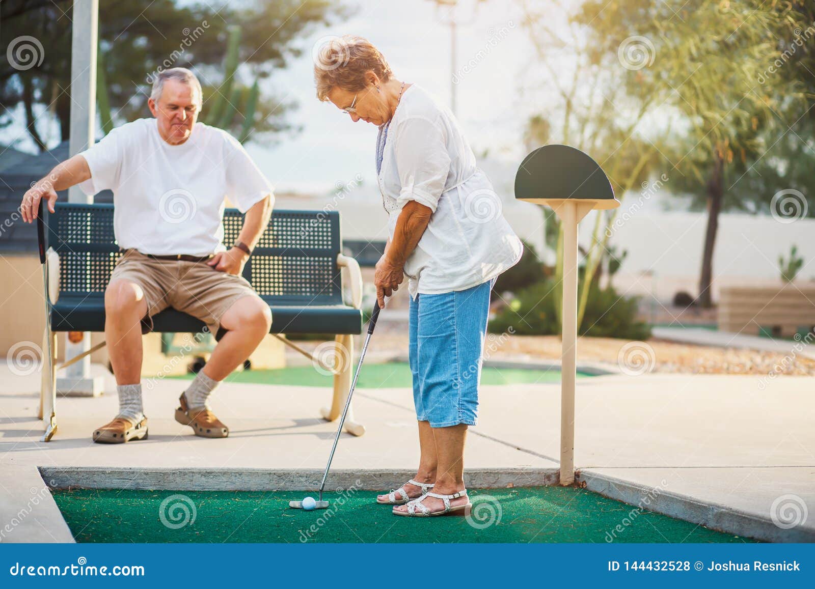 Senior Couple Playing Miniature Golf Stock Photo - Image of caucasian ...