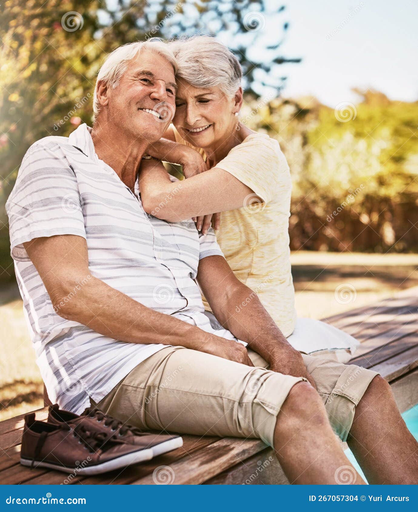 Senior Couple Relax And Smile By Pool In Love And Summer Vacation